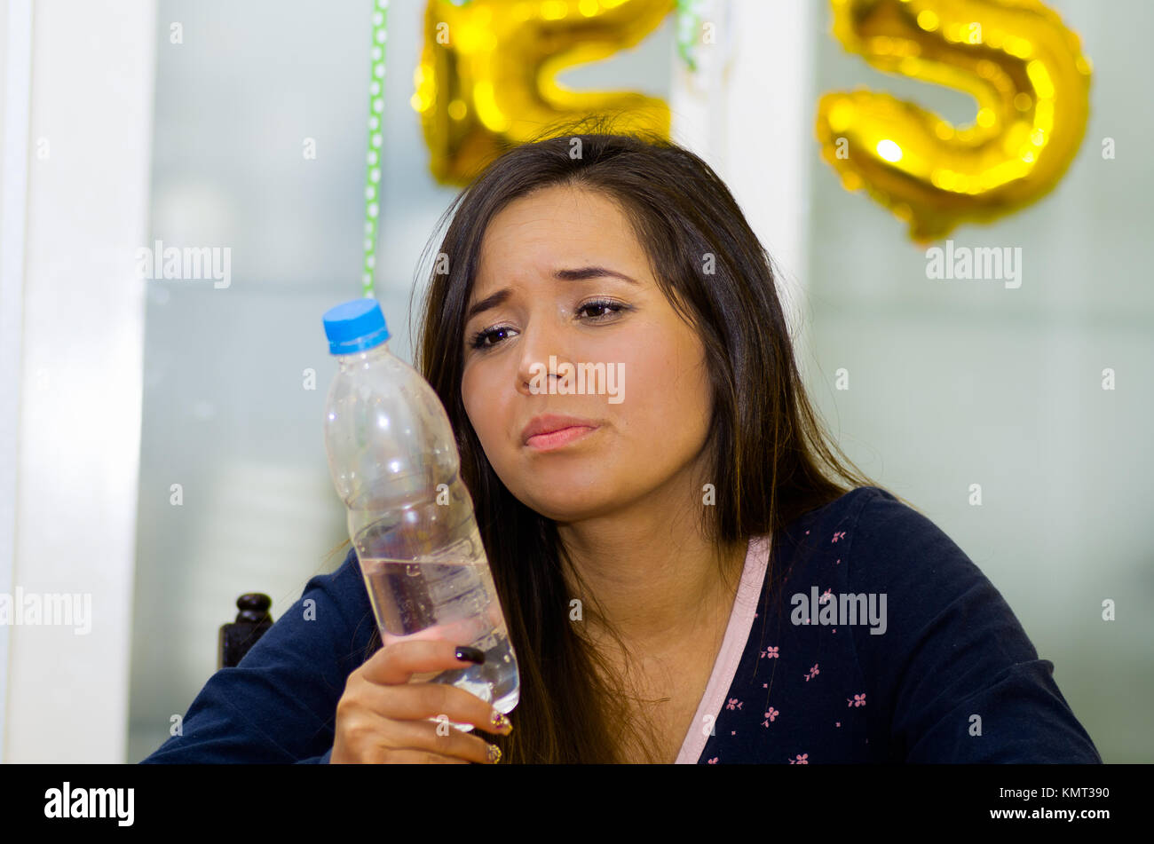 Drunk woman holding a plastic bottle of water, hangover concept Stock ...