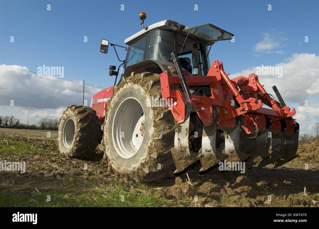 Tractor with plow at field Stock Photo - Alamy