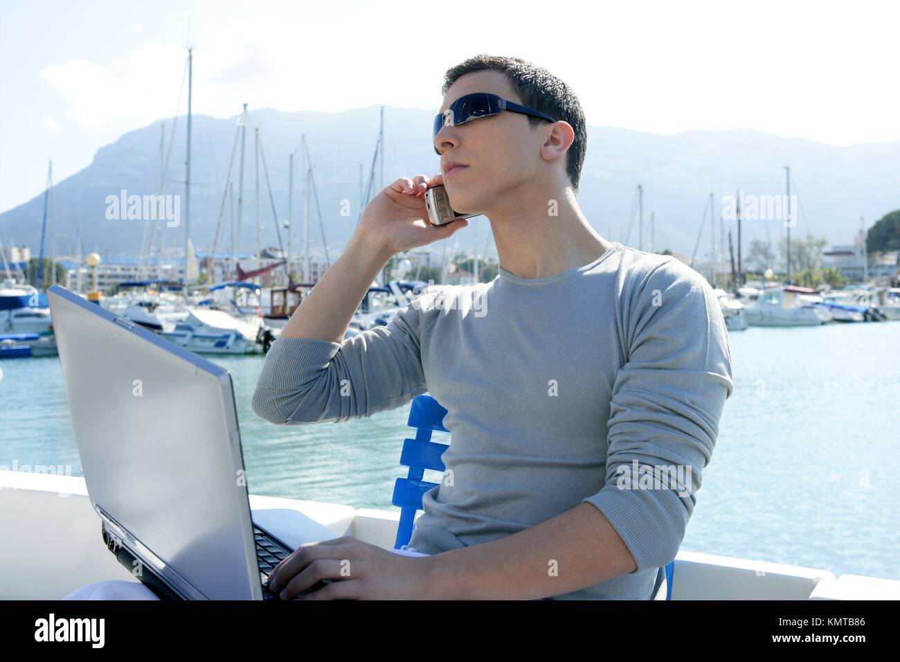Businessman working with computer on a boat, nice outdoor office Stock ...