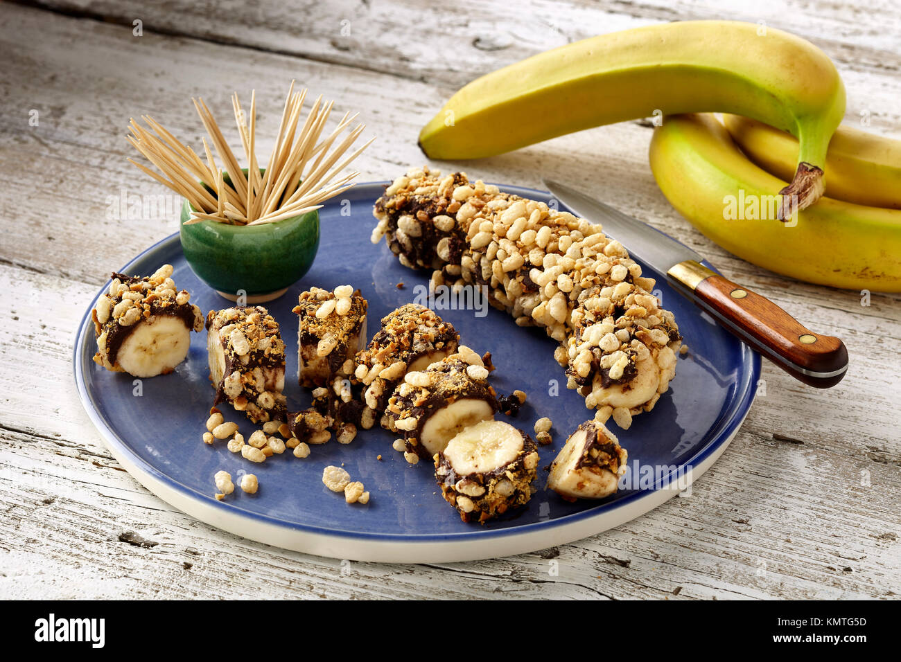 Chocolate peanut coated banana snack bites Stock Photo - Alamy