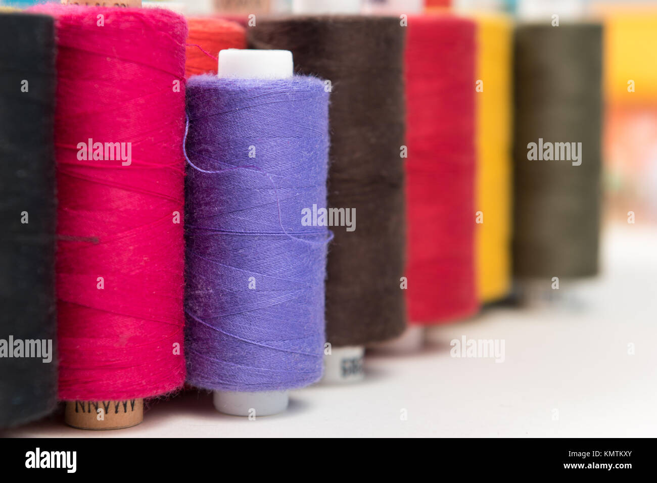 Set of standing sewing colored thread coils. Tailor equipment, textile ...
