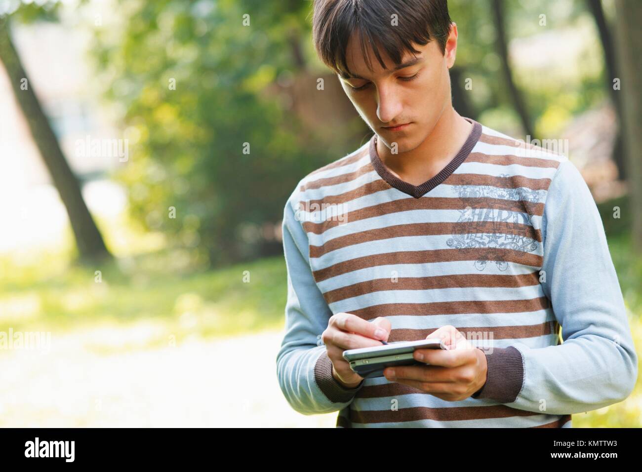 Business portraits: businessman using a PDA outdoors Stock Photo - Alamy