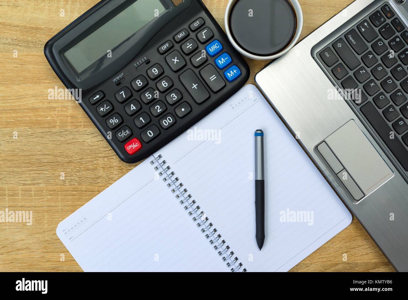 Laptop computer or notebook, calculator and cup of coffee on working ...