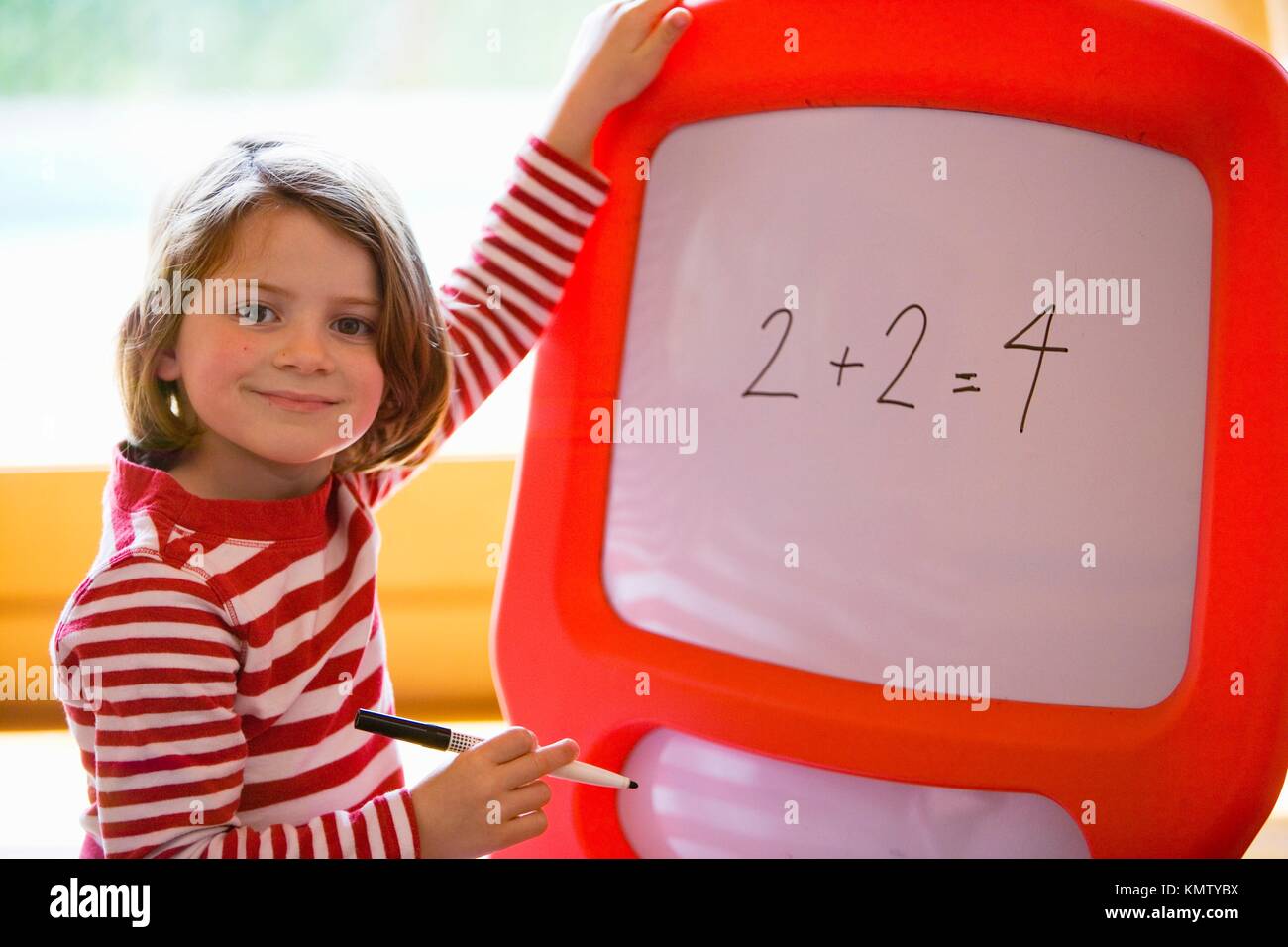 Little girl making a sum on a board Stock Photo - Alamy