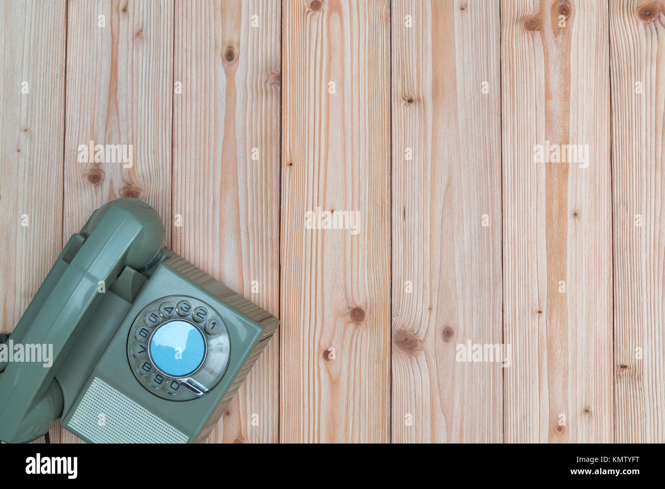 Retro rotary telephone or vintage phone with cable on wood table ...