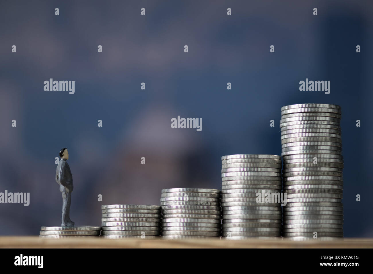 Figure miniature businessman of small people standing on first step of ...