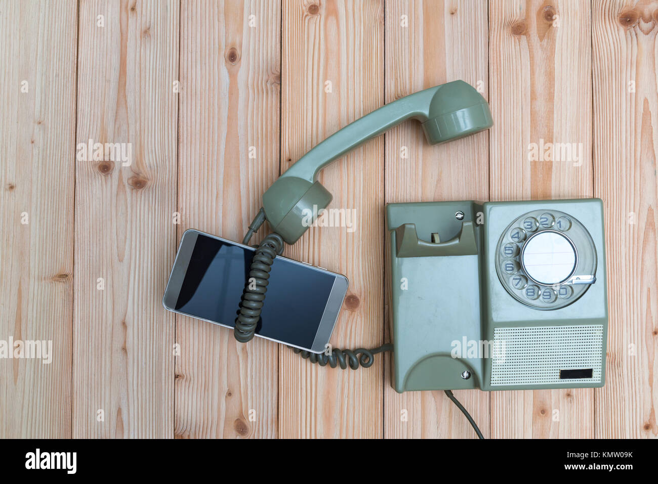 Retro rotary telephone or vintage phone with cable and new cell phone ...