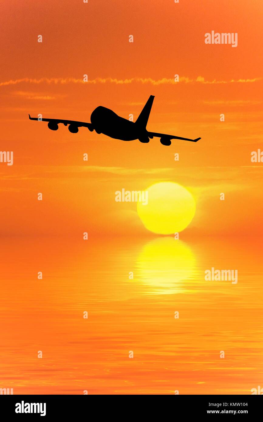 Airliner flying into the sunset over the ocean Stock Photo - Alamy