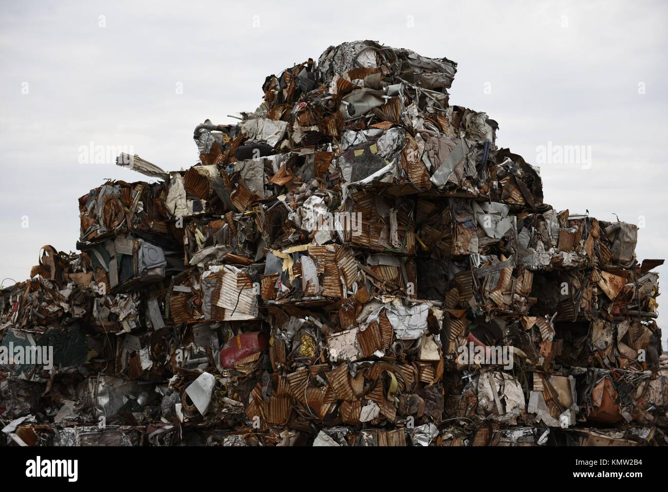Scrap metal recycling in the USA, large tall stack of compacted ...