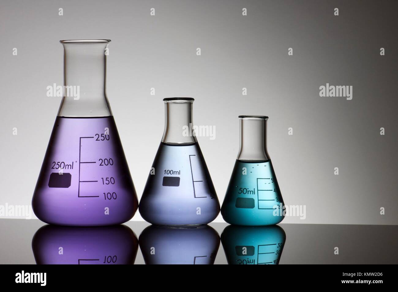 group of three conical flasks containing liquid shiny Stock Photo - Alamy