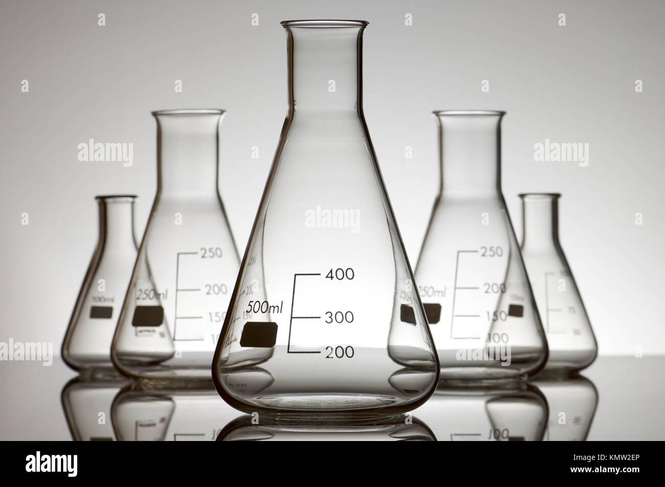 five empty flasks on a white backlight Stock Photo - Alamy