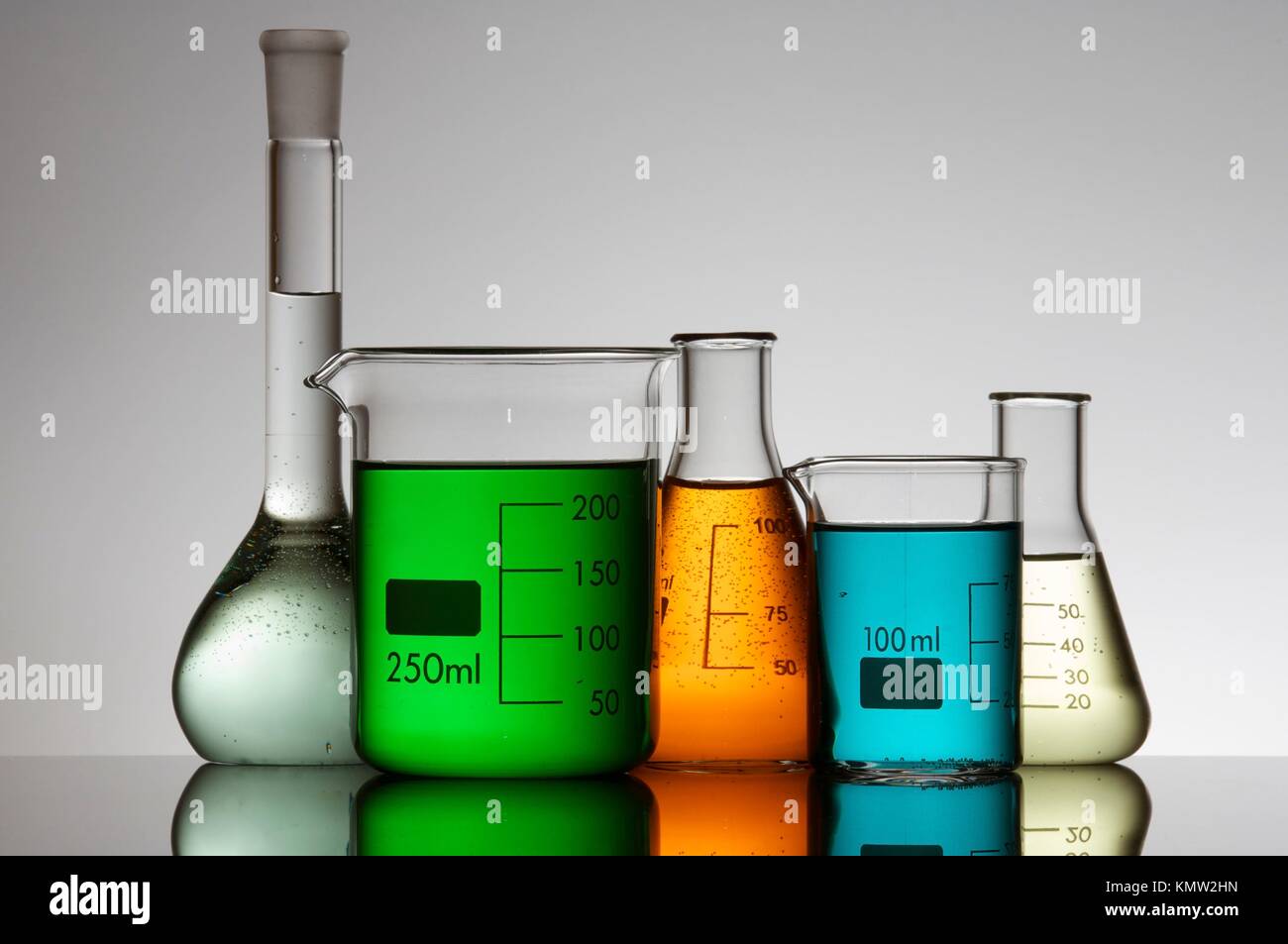 group of five beakers containing colored liquid Stock Photo - Alamy