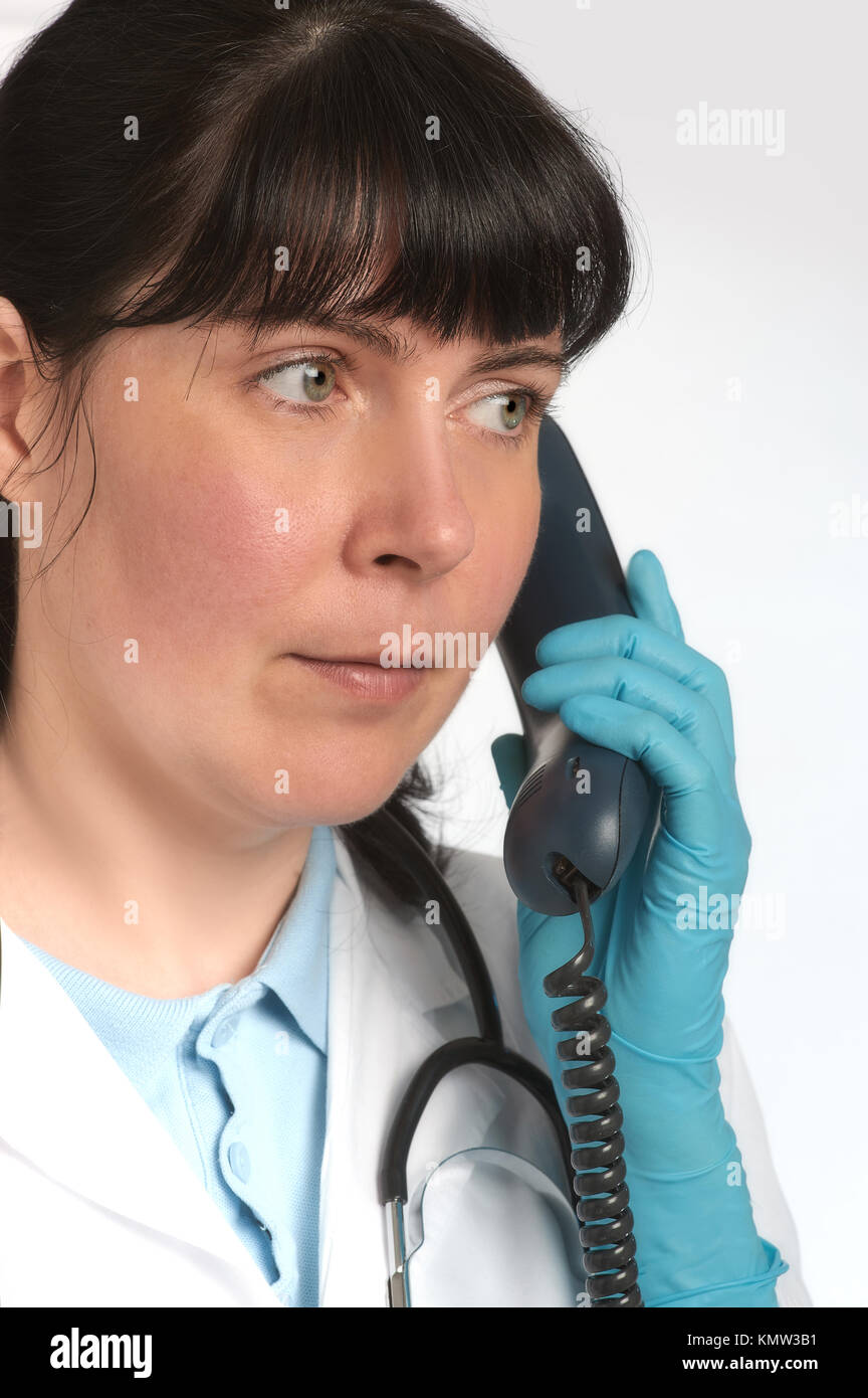 Doctor woman listening phone hi-res stock photography and images - Alamy