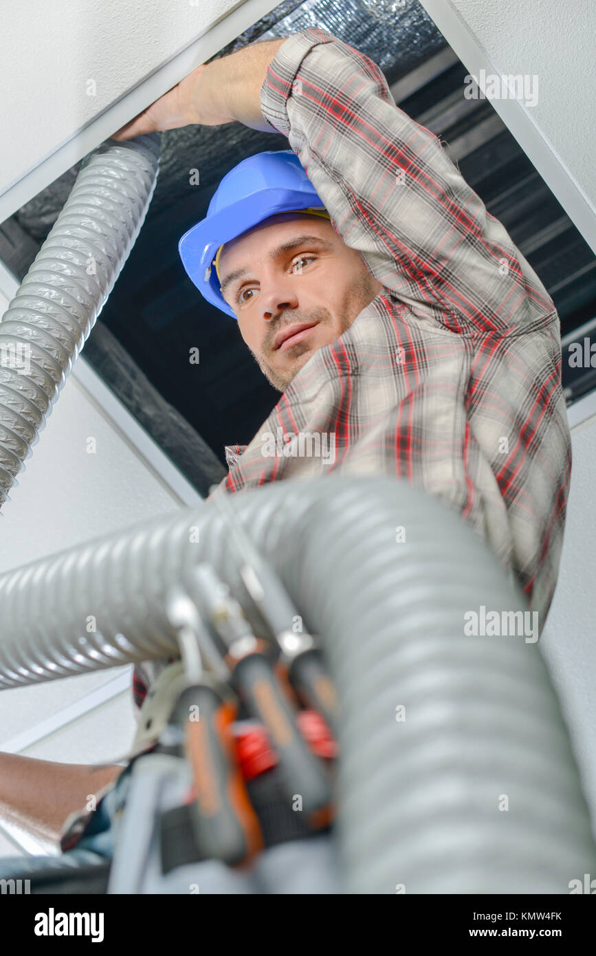 Construction worker placing a pipe Stock Photo - Alamy