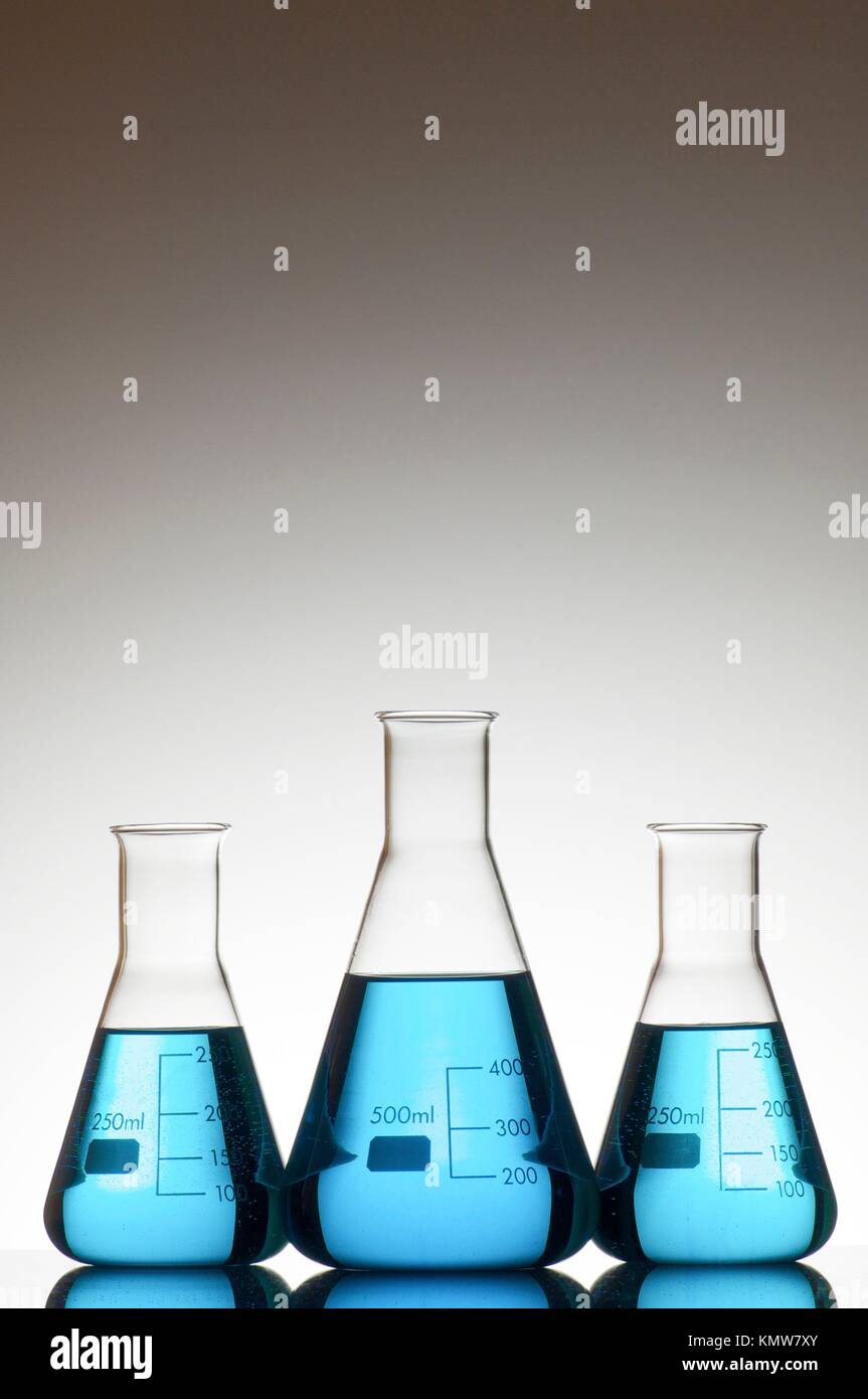 three flasks with liquid blue and white background Stock Photo - Alamy