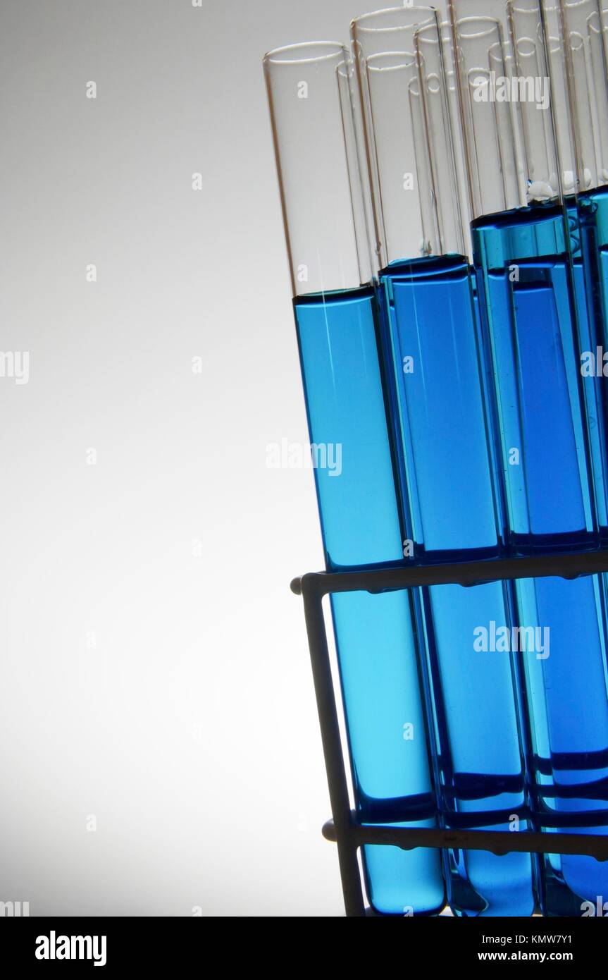 blue test tubes in a rack with white background Stock Photo - Alamy