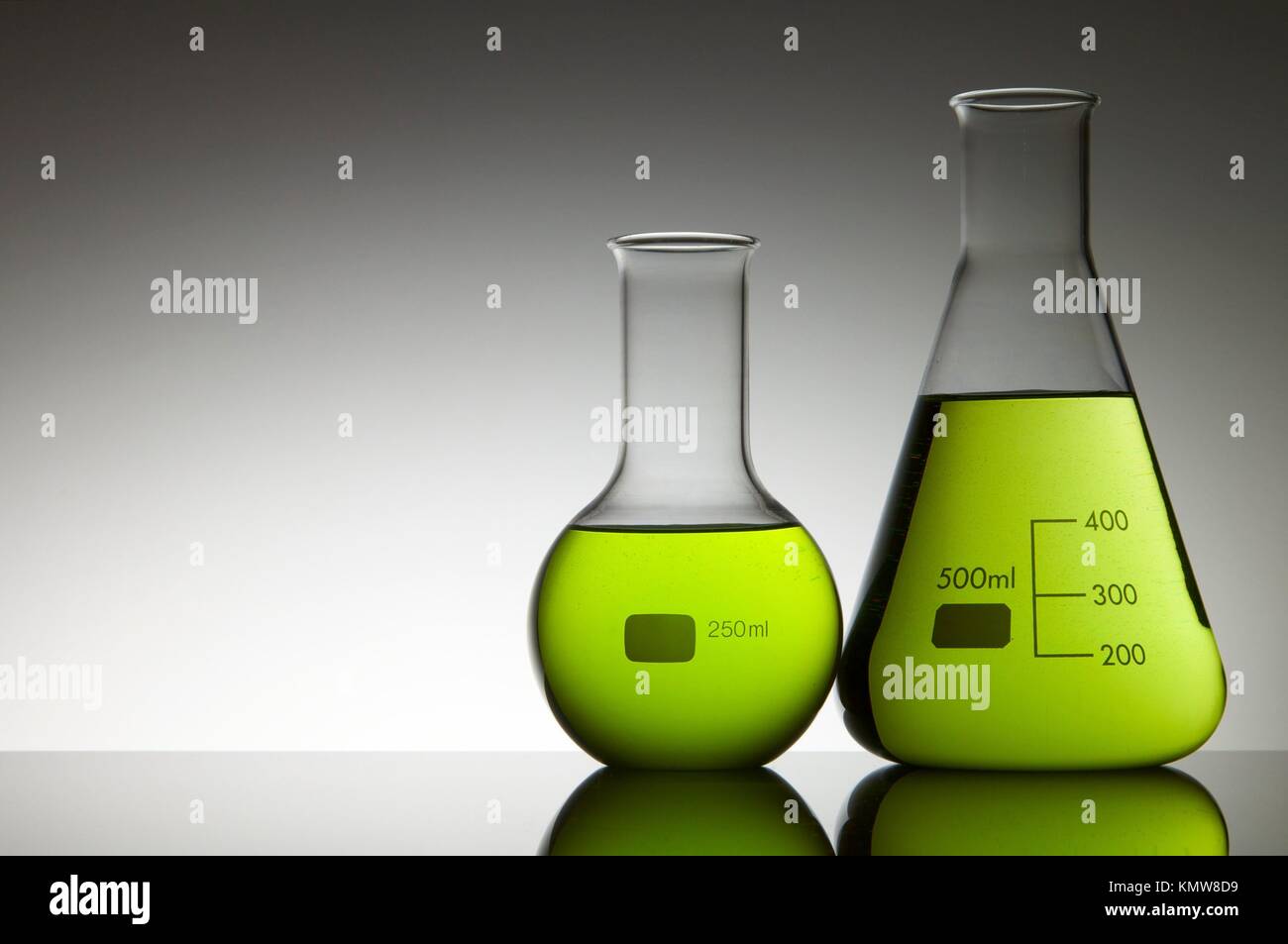 two flasks with liquid bright green and white background Stock Photo ...