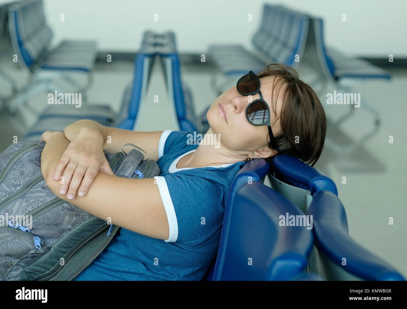 Tired woman sleeping airport hi-res stock photography and images - Alamy