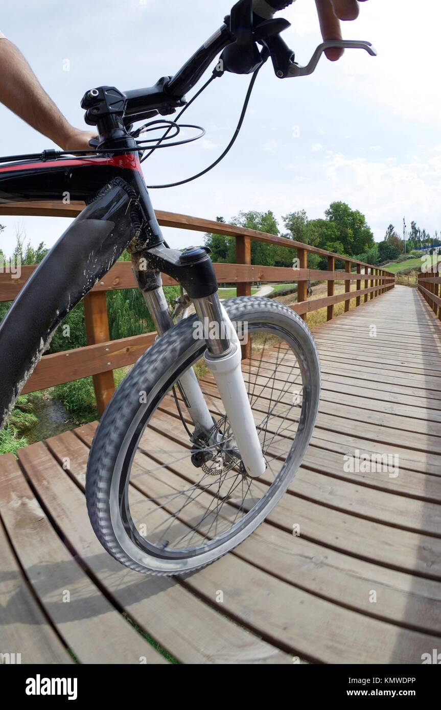 Low angle view of a mountain bike across a wooden walkway Stock Photo ...