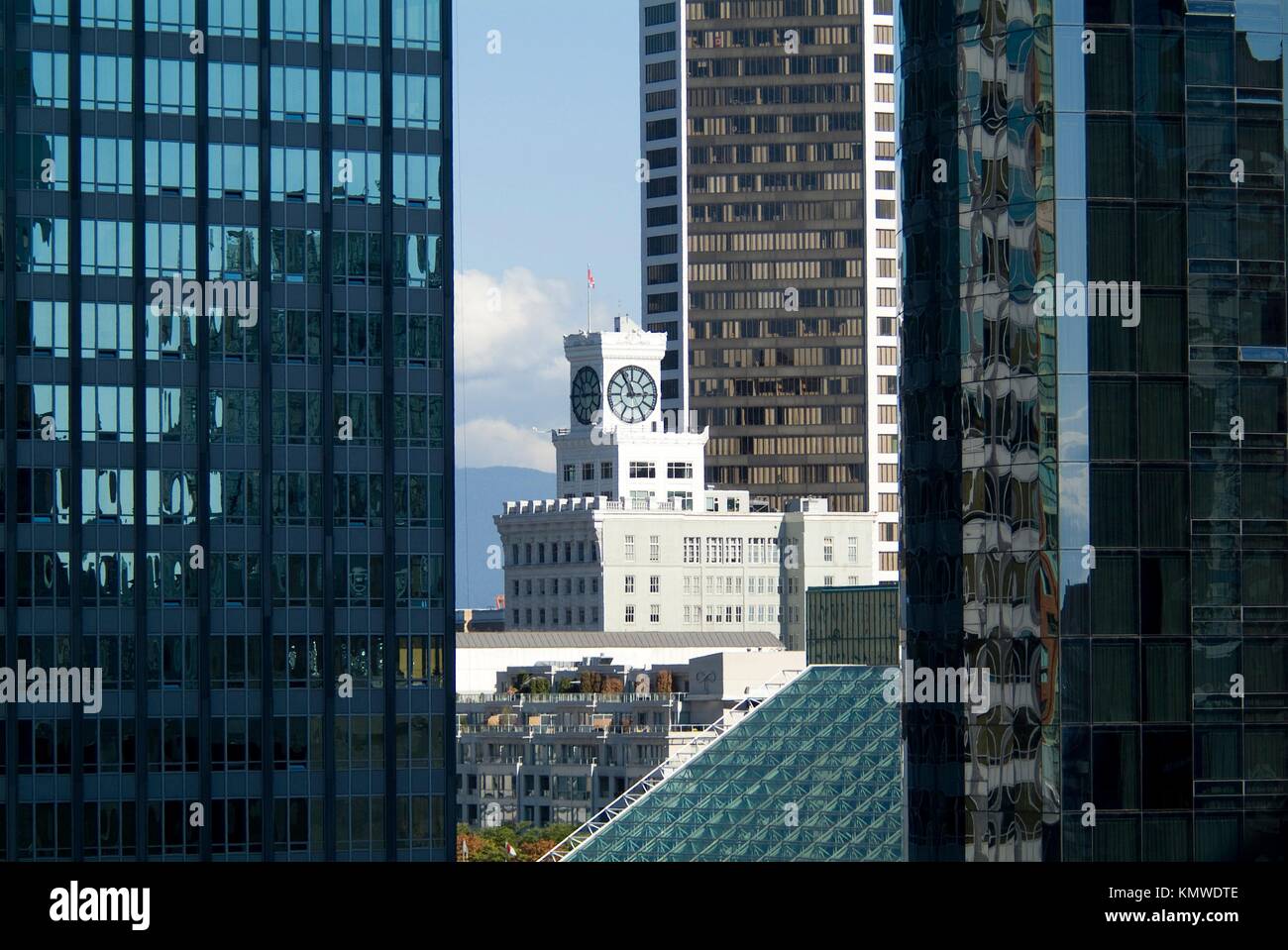 the clock tower on the Vancouver Block stands out against the more ...