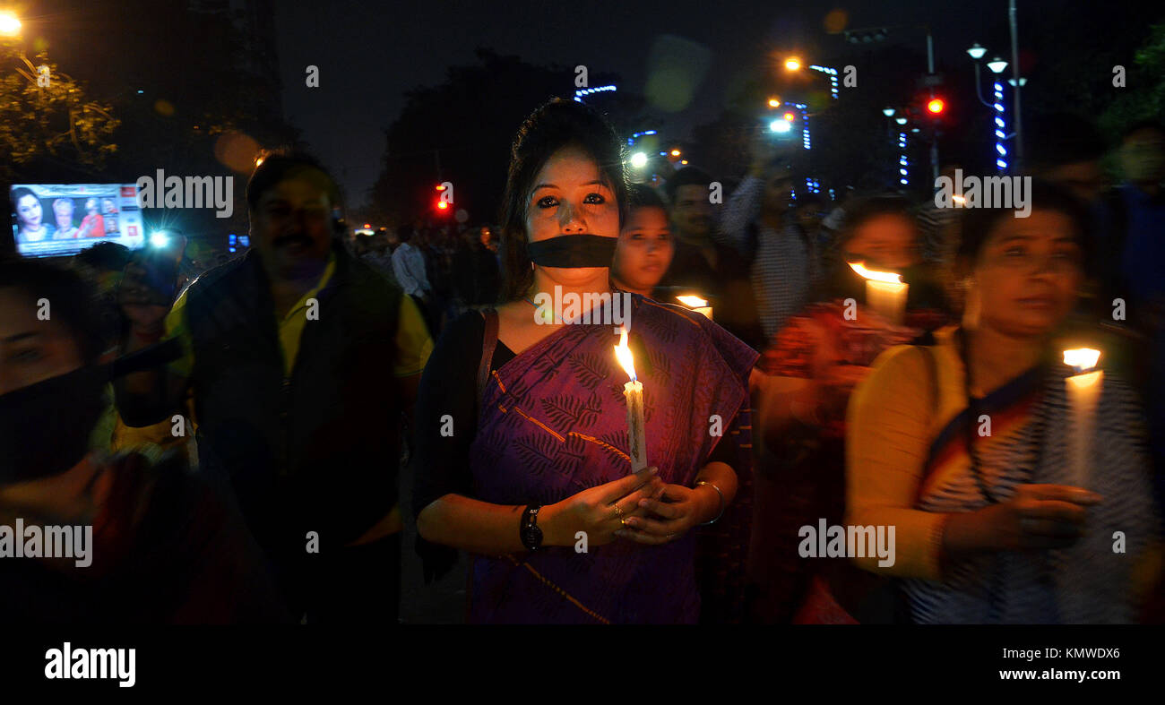 supporters of Trinamool Congress hold a candle during a candle rally to ...