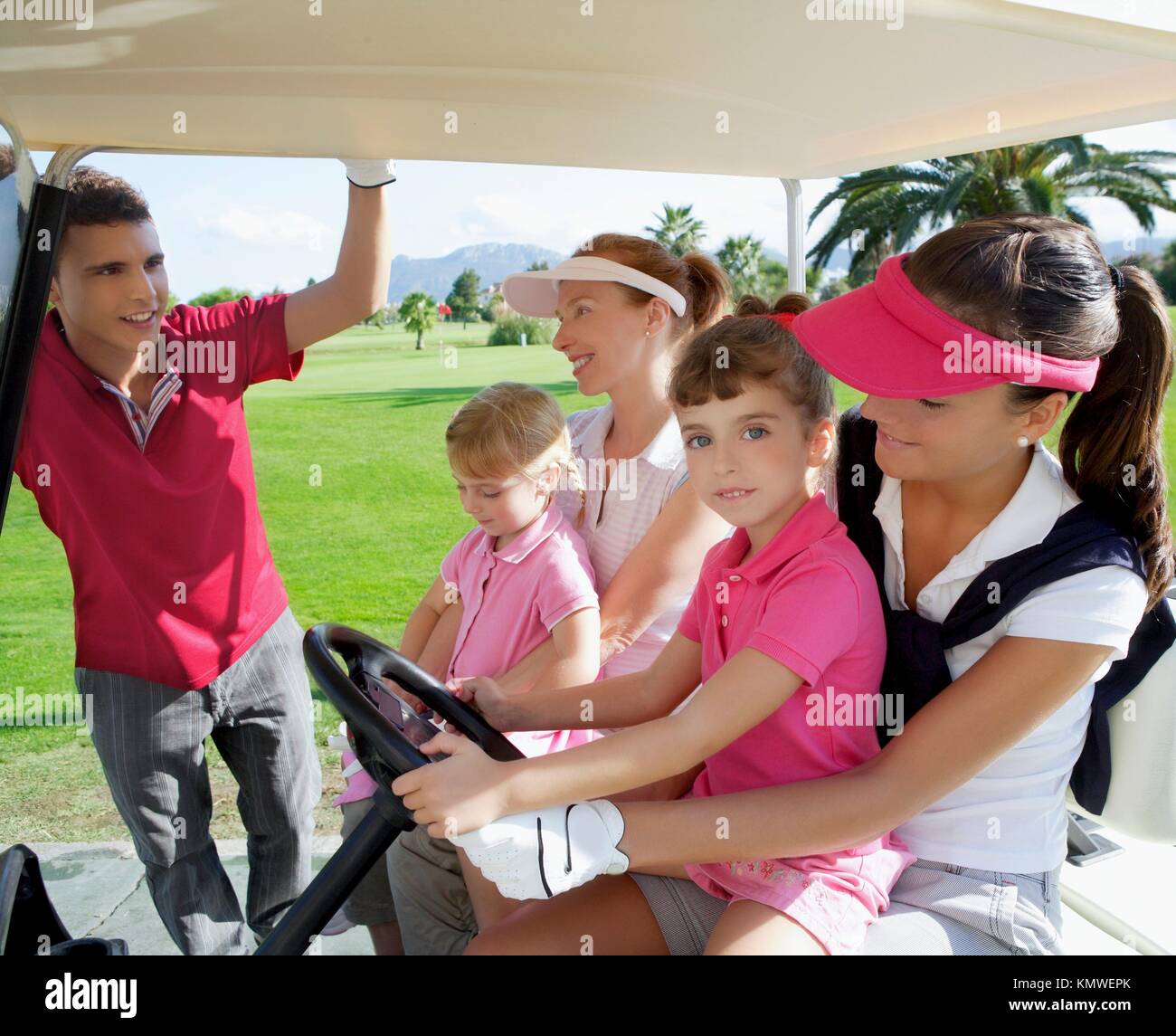 golf course mothers and daughters in buggy talking father Stock Photo ...