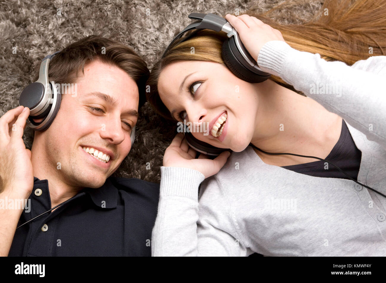 Young couple listening music Stock Photo - Alamy