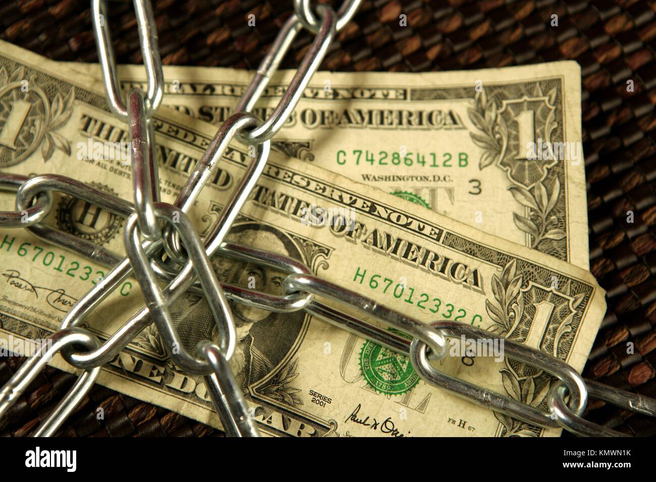 One Dollar notes in chains studio shot over brown background Stock ...