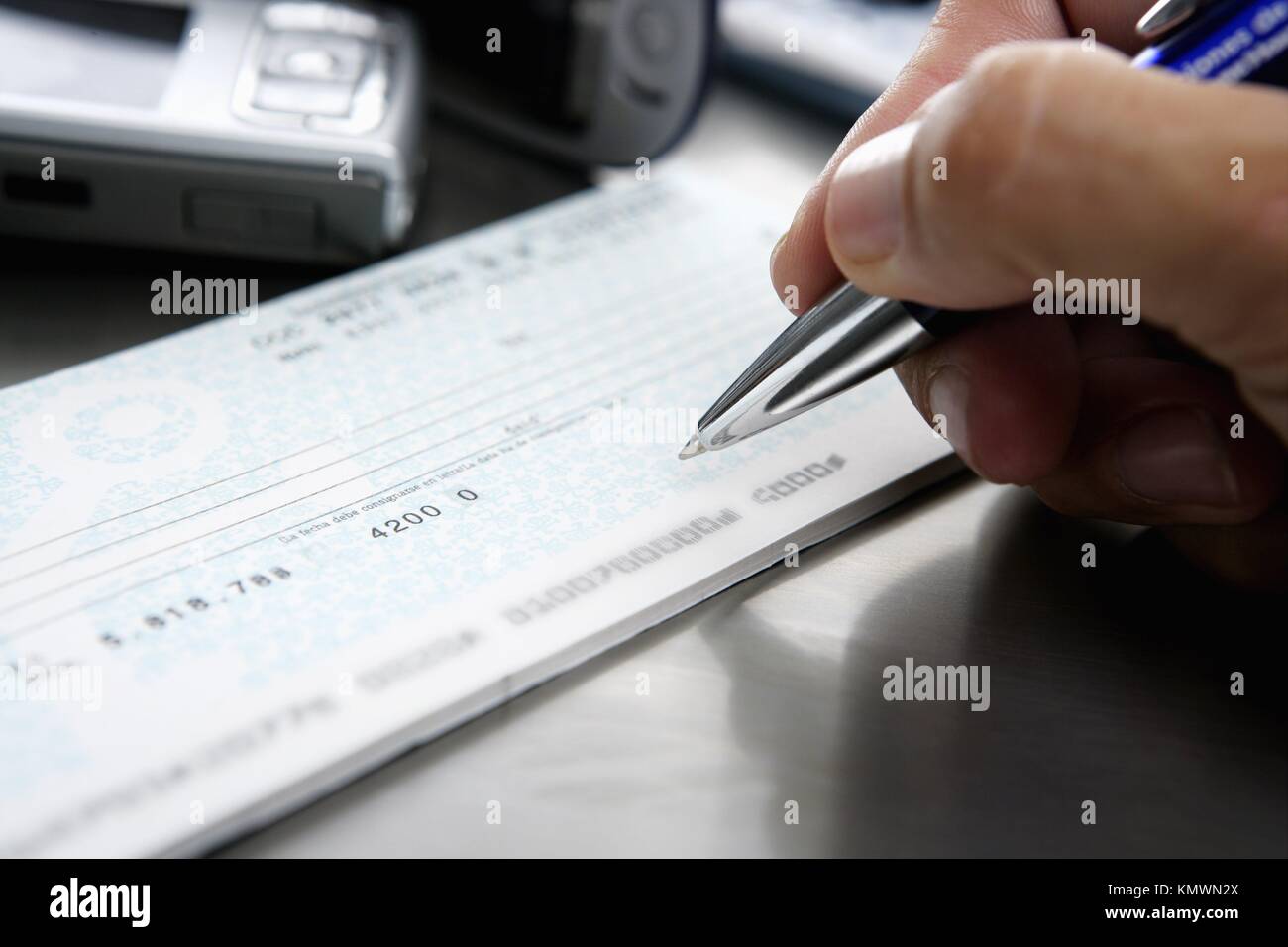 Signing a cheque hi-res stock photography and images - Alamy