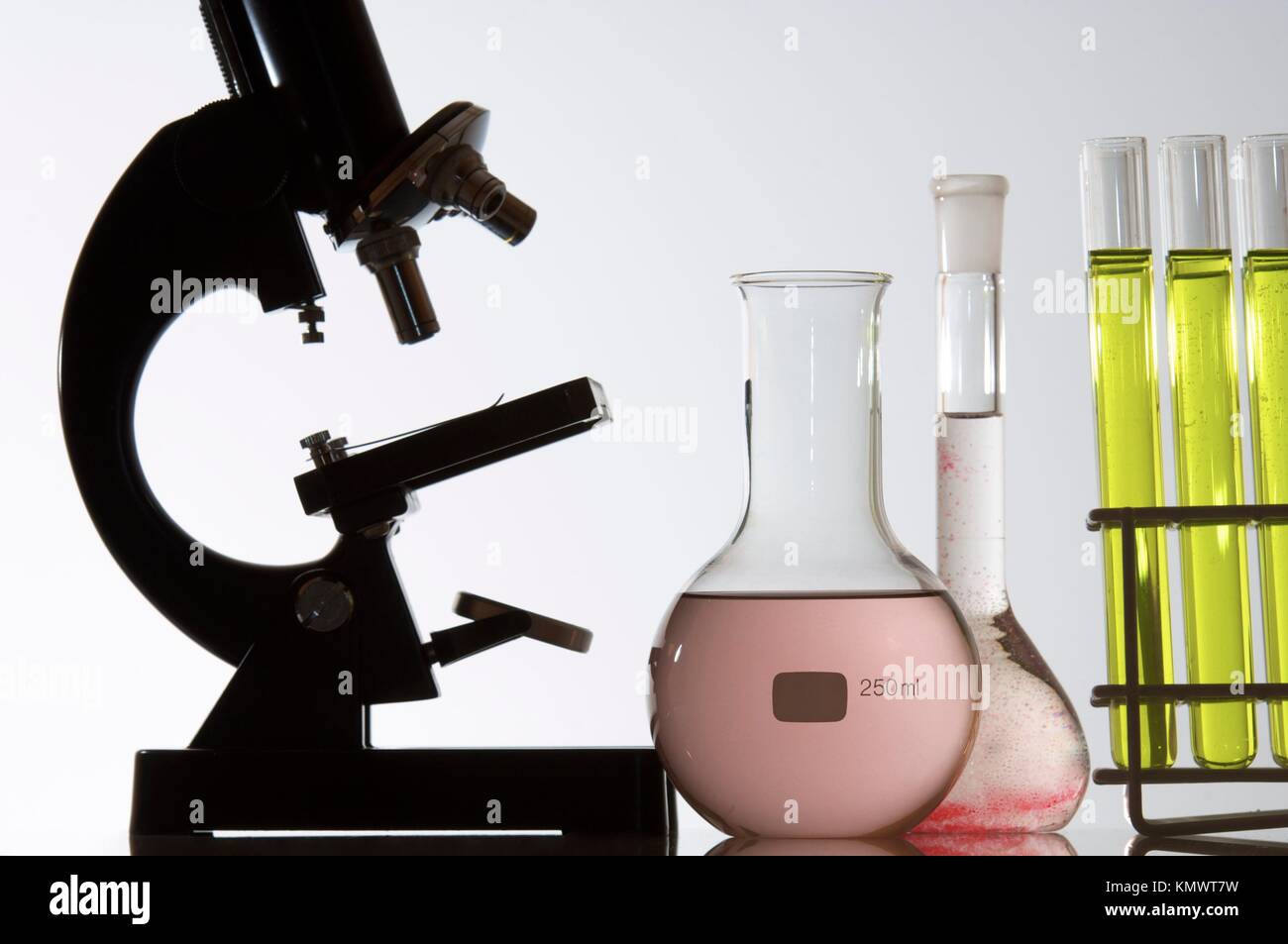 research microscope and laboratory bottles with colored liquid Stock ...