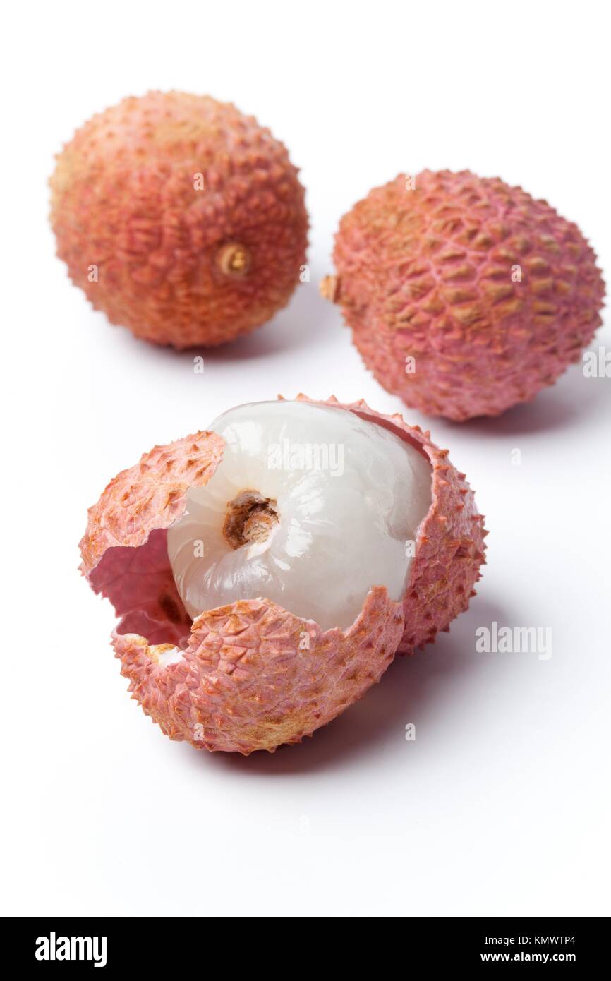 Three lychees on white background Stock Photo - Alamy