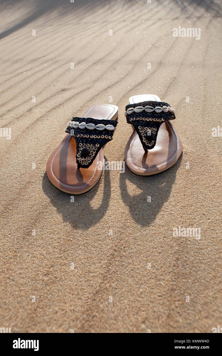 Left slippers on the sand Stock Photo - Alamy