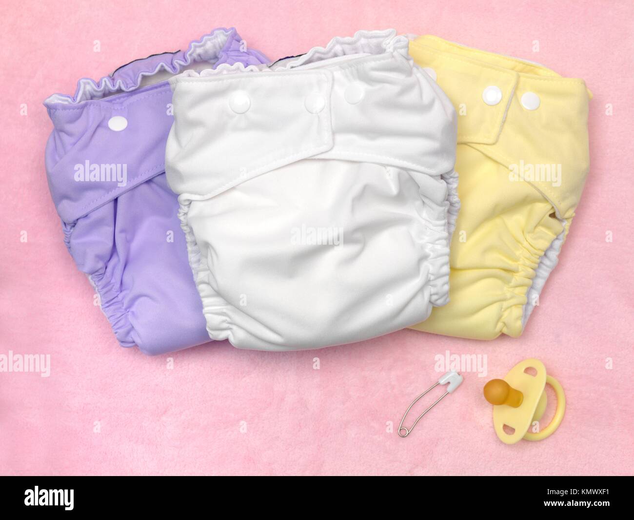 A modern cloth nappy isolated against a pink background Stock Photo - Alamy