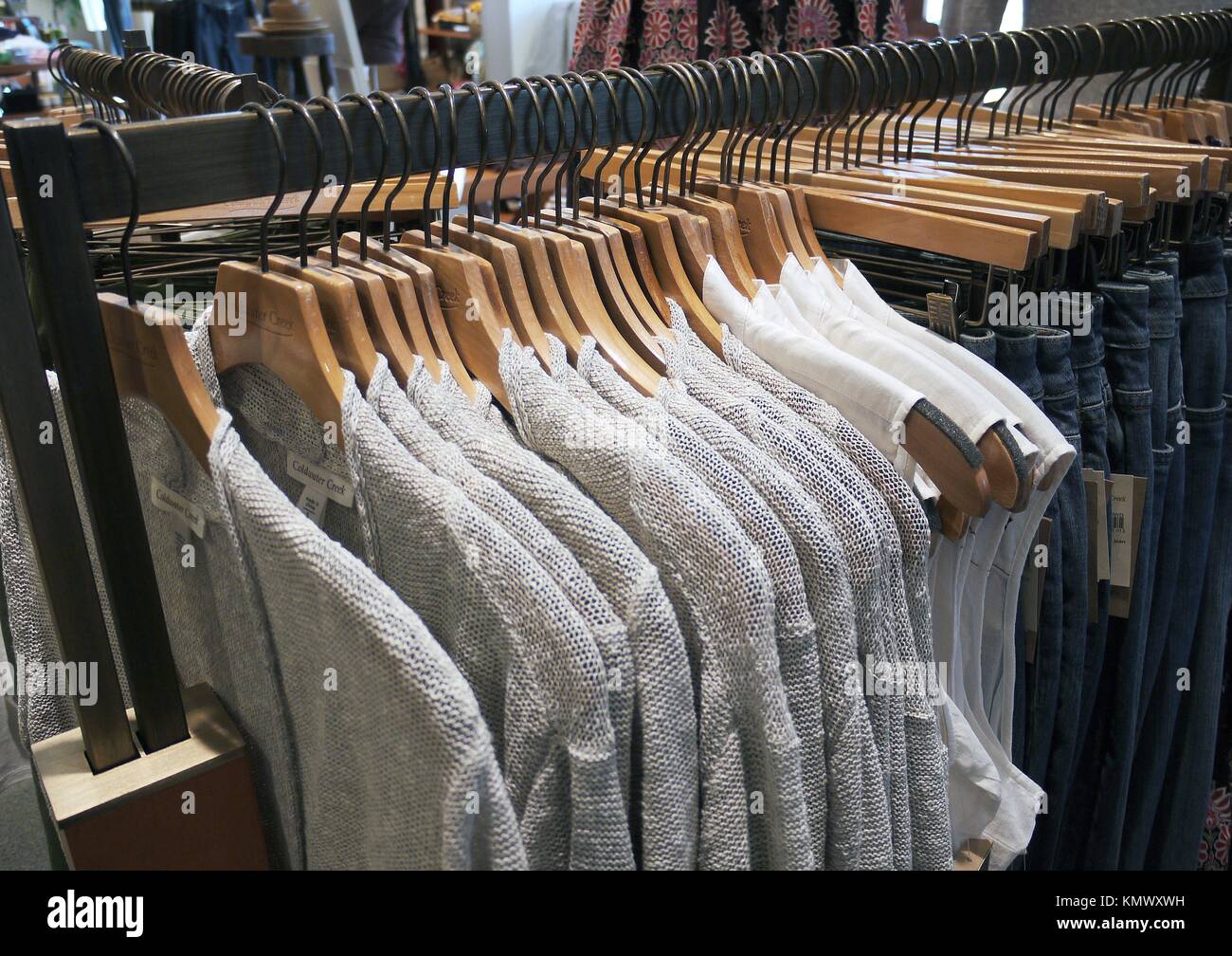 Tees hirts on a store rack Stock Photo - Alamy