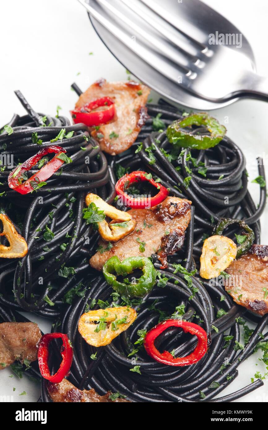 sepia spaghetti with turkey meat and chilli Stock Photo - Alamy