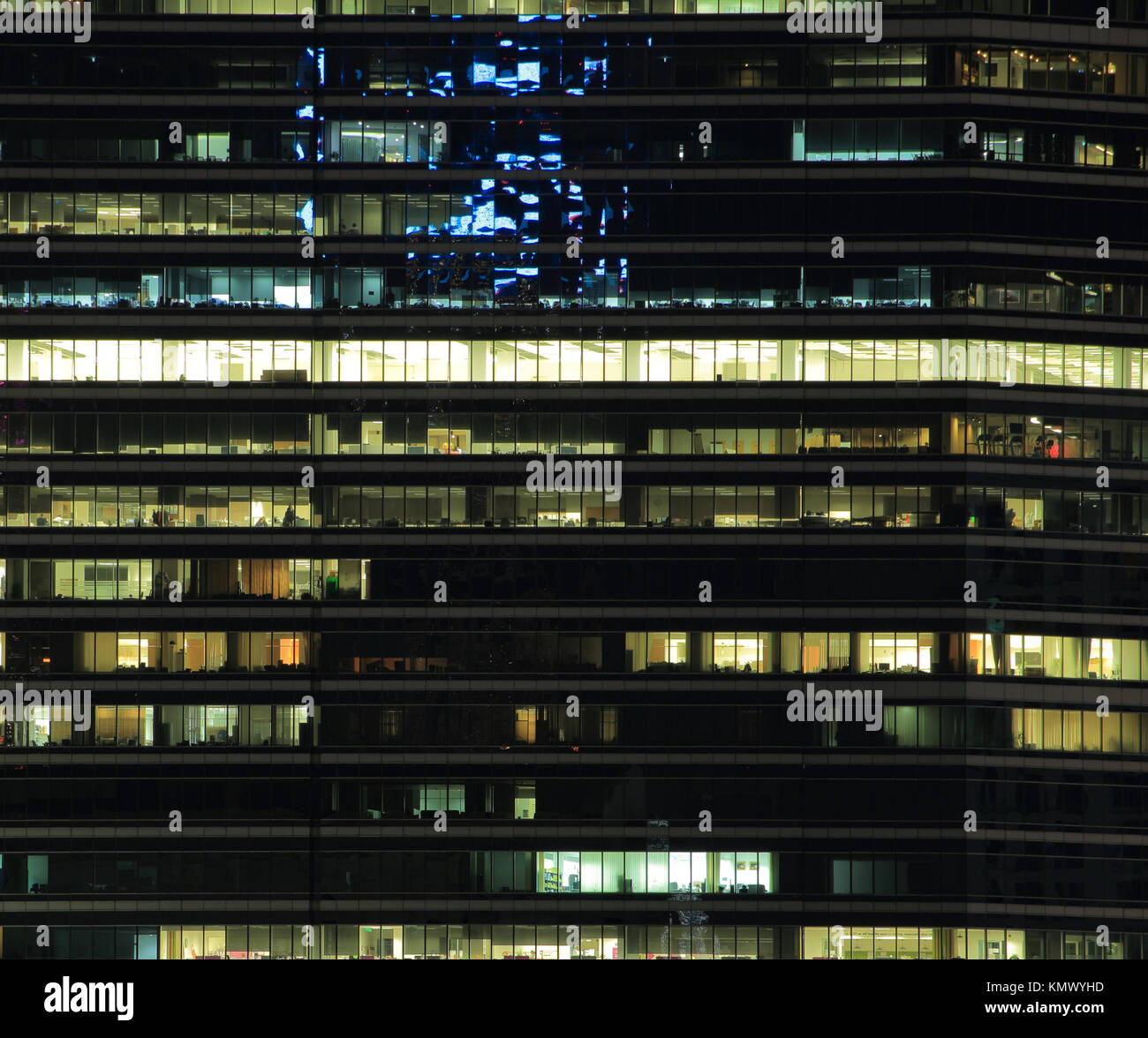 office building at night. Late night at work. Glass curtain wall office ...