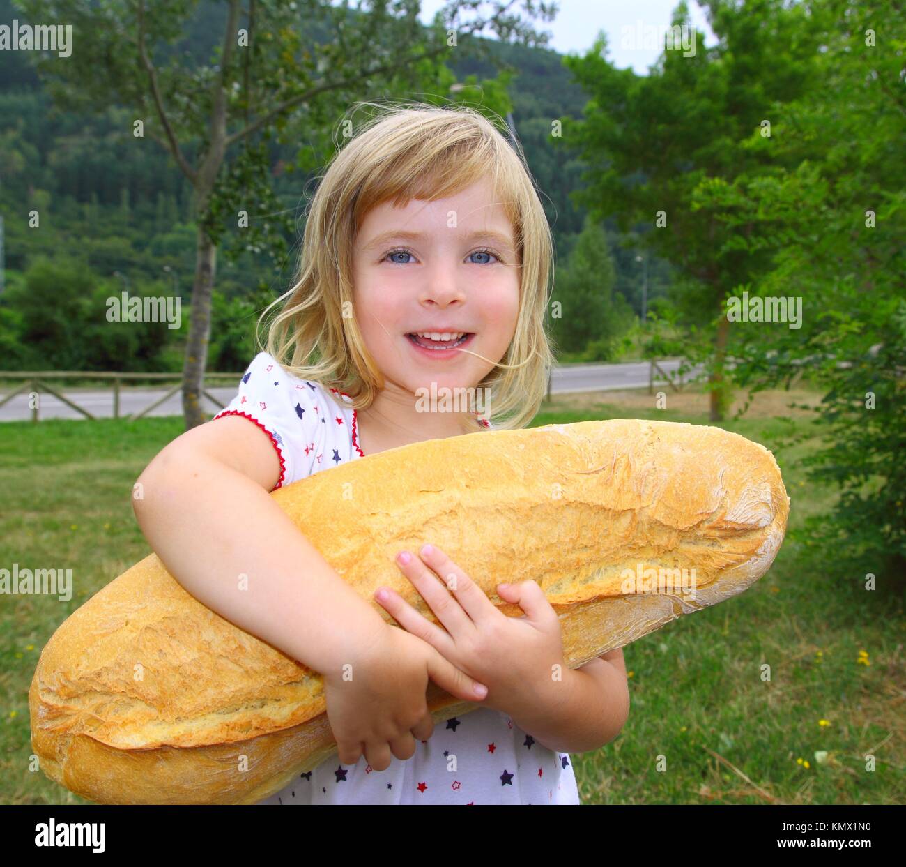 girl holding big bread humor size hungry child funny gesture Stock ...