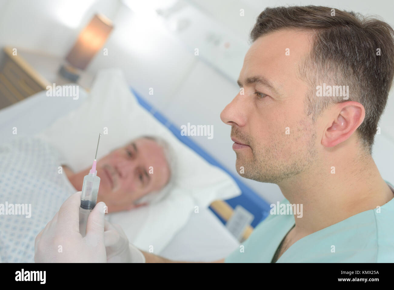 Medic preparing injection for male patient Stock Photo - Alamy