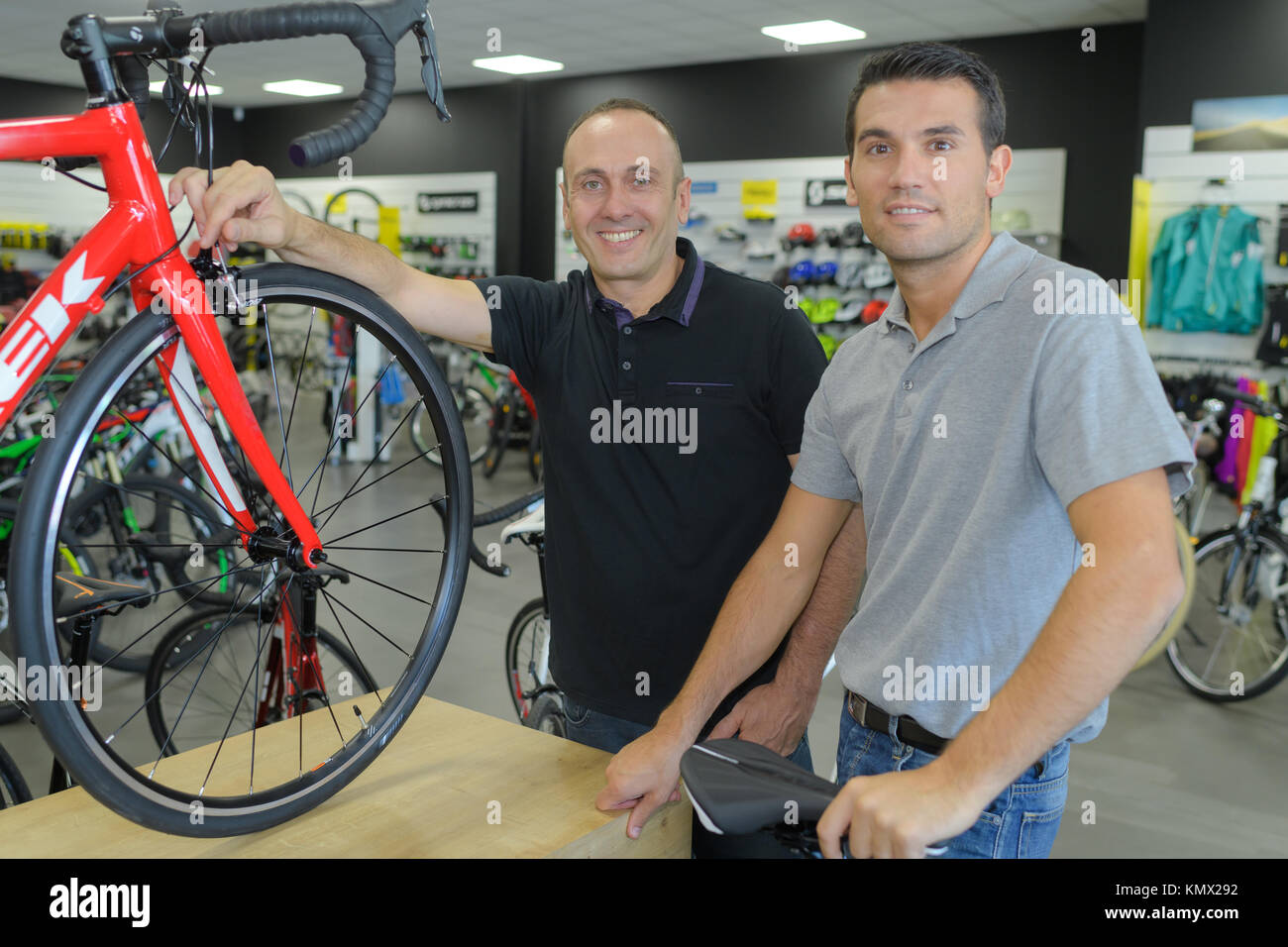 Portrait of two men in bicycle shop Stock Photo - Alamy