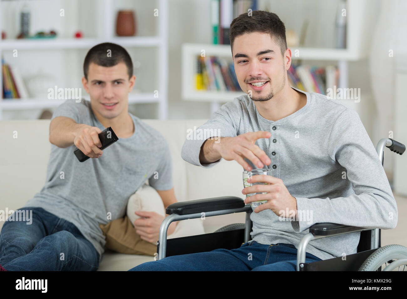 handicapped man using remote control while watching tv Stock Photo - Alamy