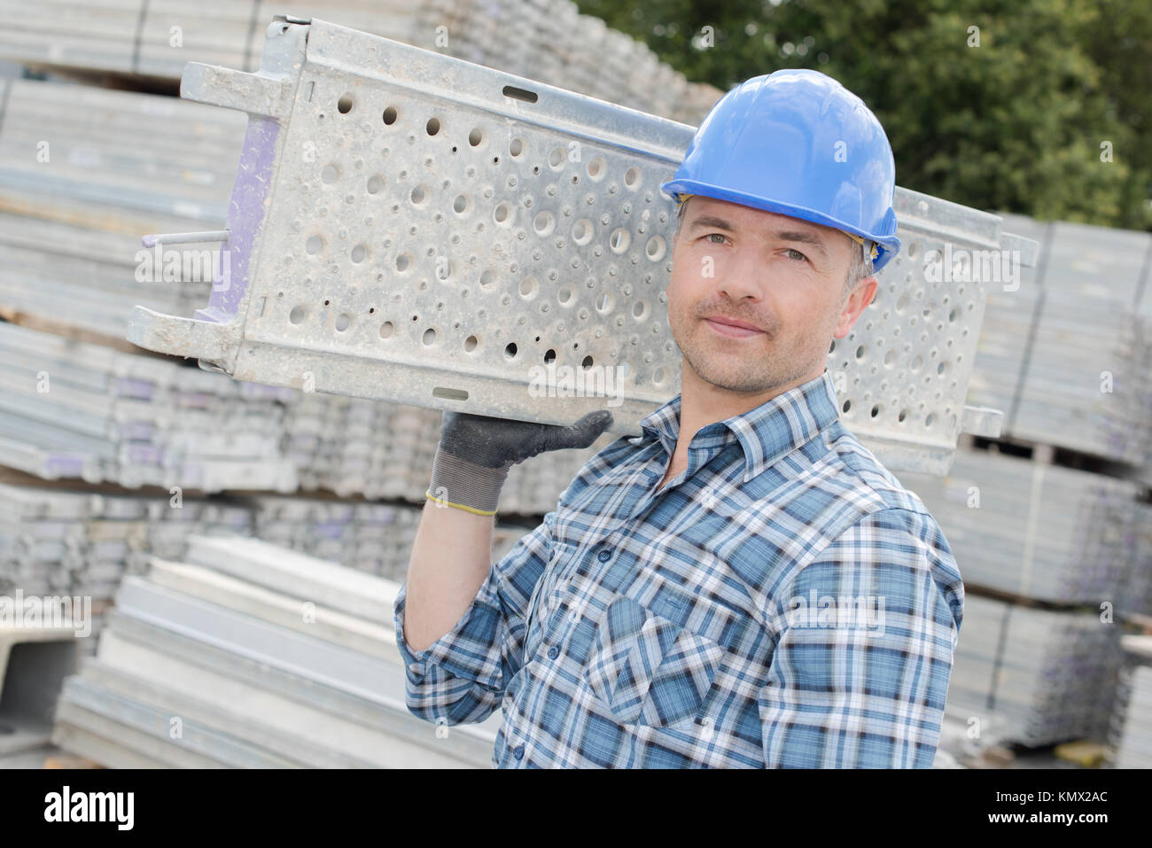 Man carrying metal platform Stock Photo - Alamy