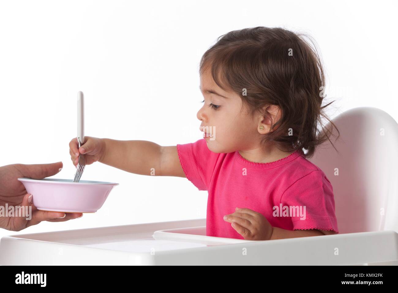 Baby girl eating by herself hi-res stock photography and images - Alamy