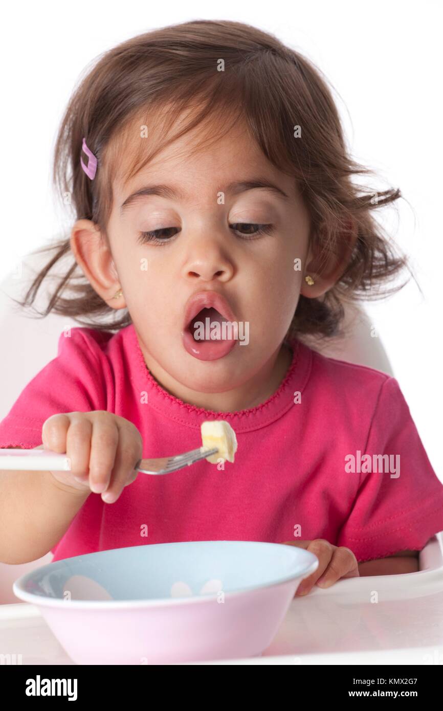 Baby girl eating by herself hi-res stock photography and images - Alamy