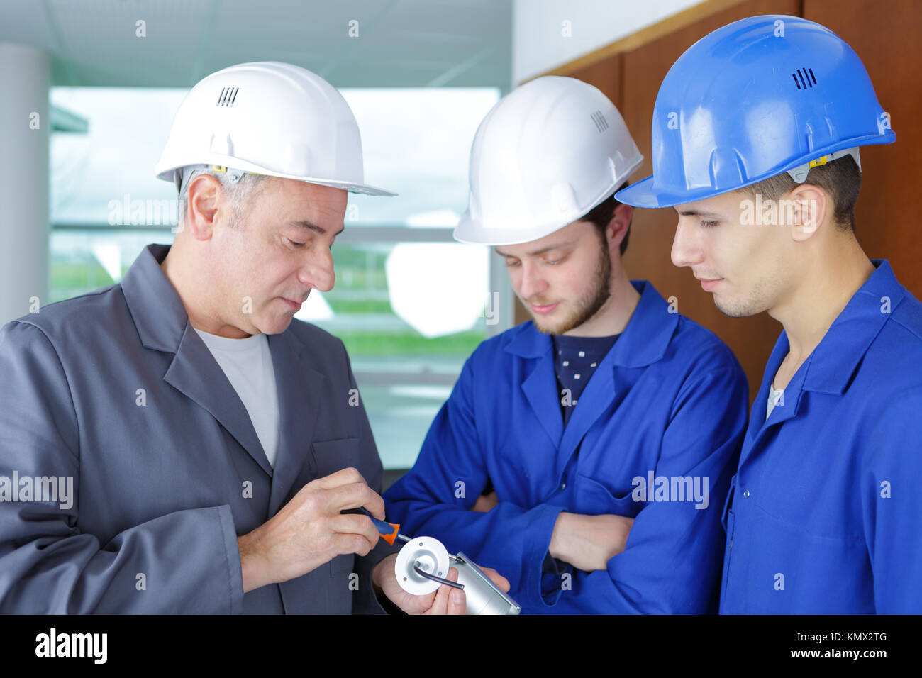 young apprentices with professional electrician Stock Photo - Alamy