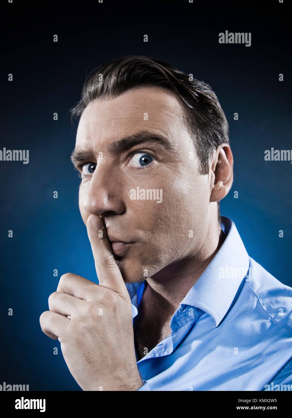 caucasian man hush sign portrait isolated studio on black background ...