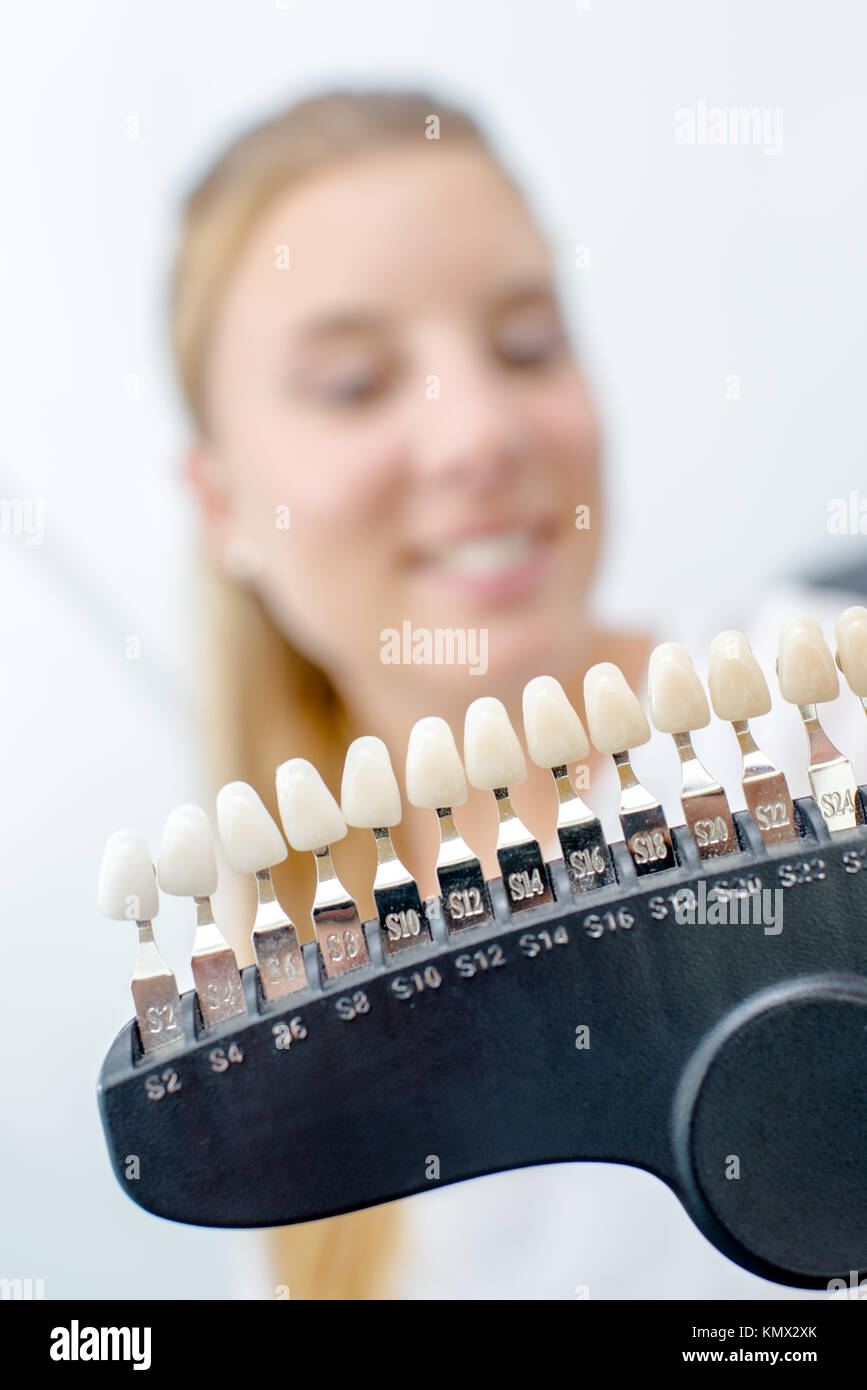 Lady smiling behind row of false teeth Stock Photo - Alamy