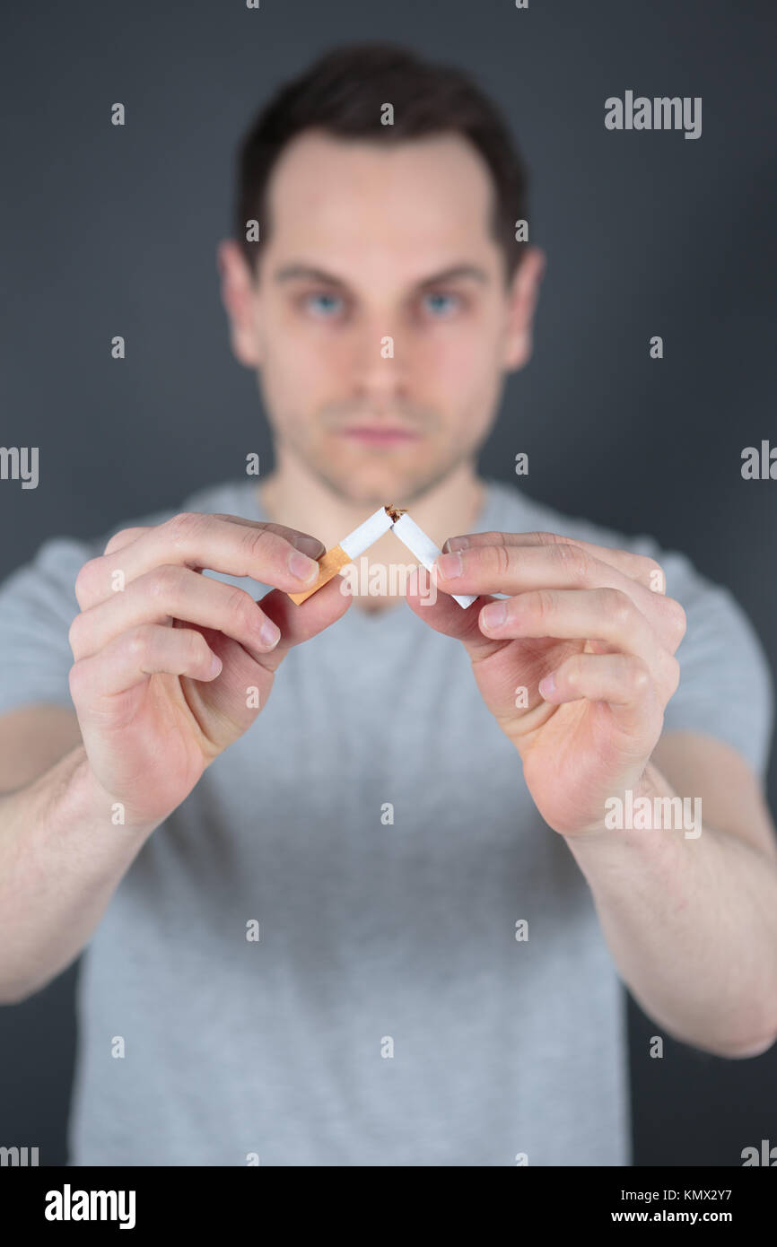 Young man breaking stick hi-res stock photography and images - Alamy