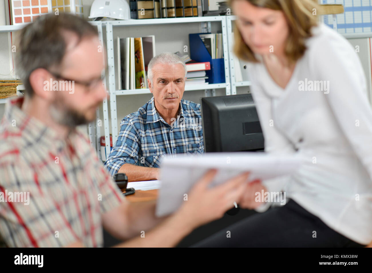 Three people working in an office Stock Photo - Alamy