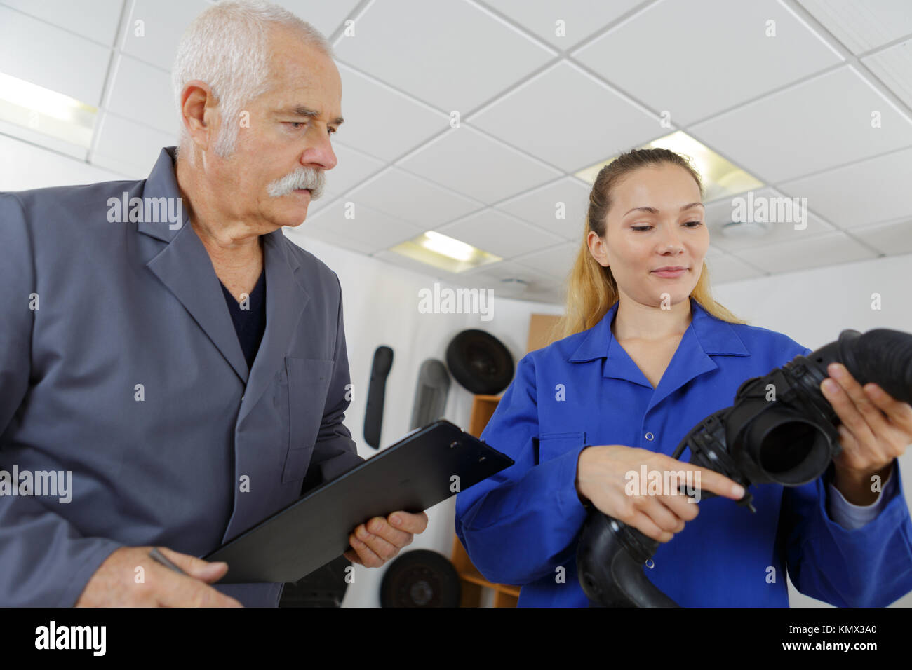 teacher asking the apprentice Stock Photo - Alamy