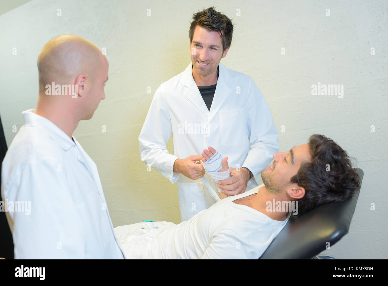 Patient having hand bandaged by doctor Stock Photo - Alamy